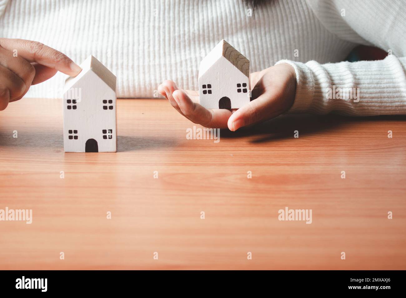 Woman's hand with a small house in hand, vintage style Stock Photo - Alamy