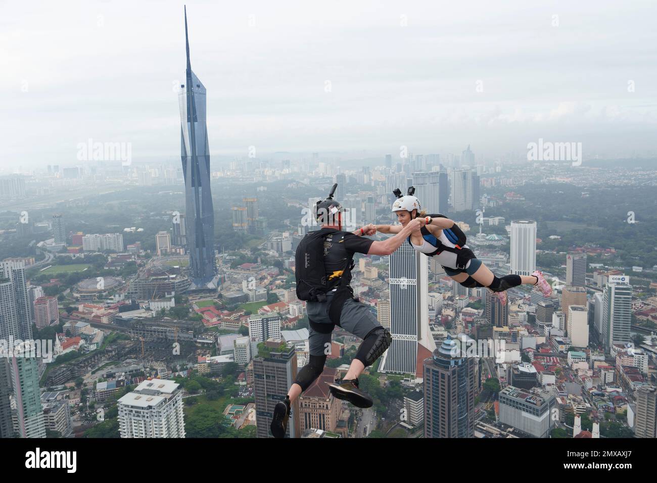 A pair of BASE jumpers dive from the Kuala Lumpur Tower during the KL Tower International Jump ...