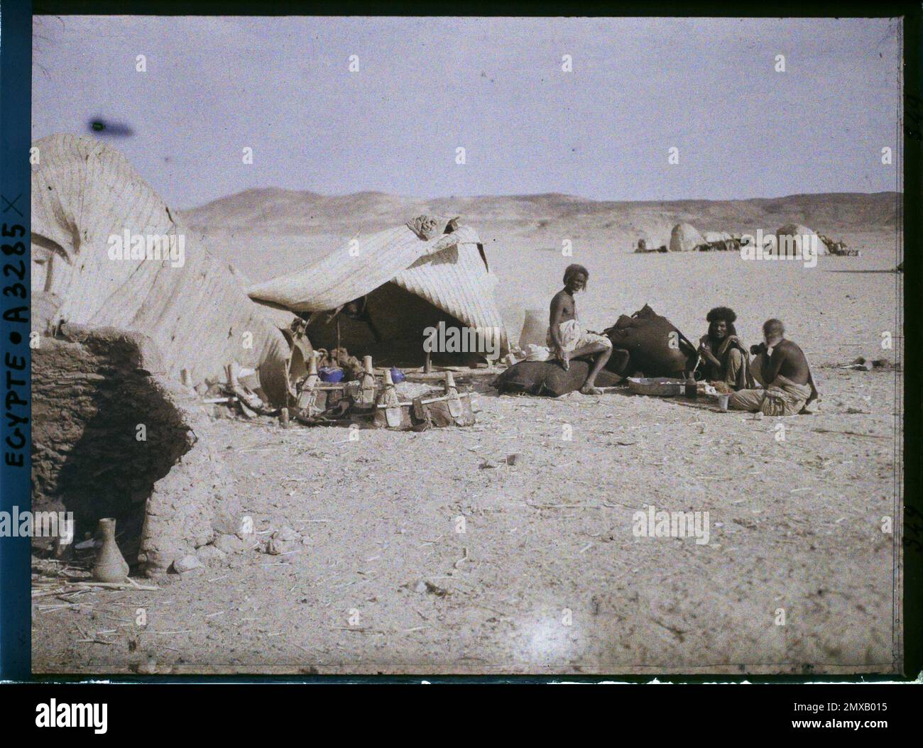 ASSOUAN, Egypt, Africa three men bishari seated in front of their homes ...