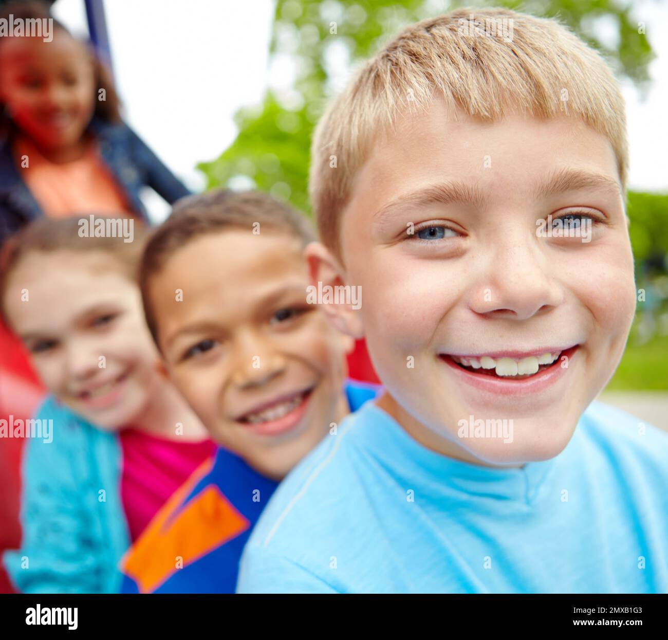 Giving you a cheerful smile. A happy group of multi-ethnic children ...