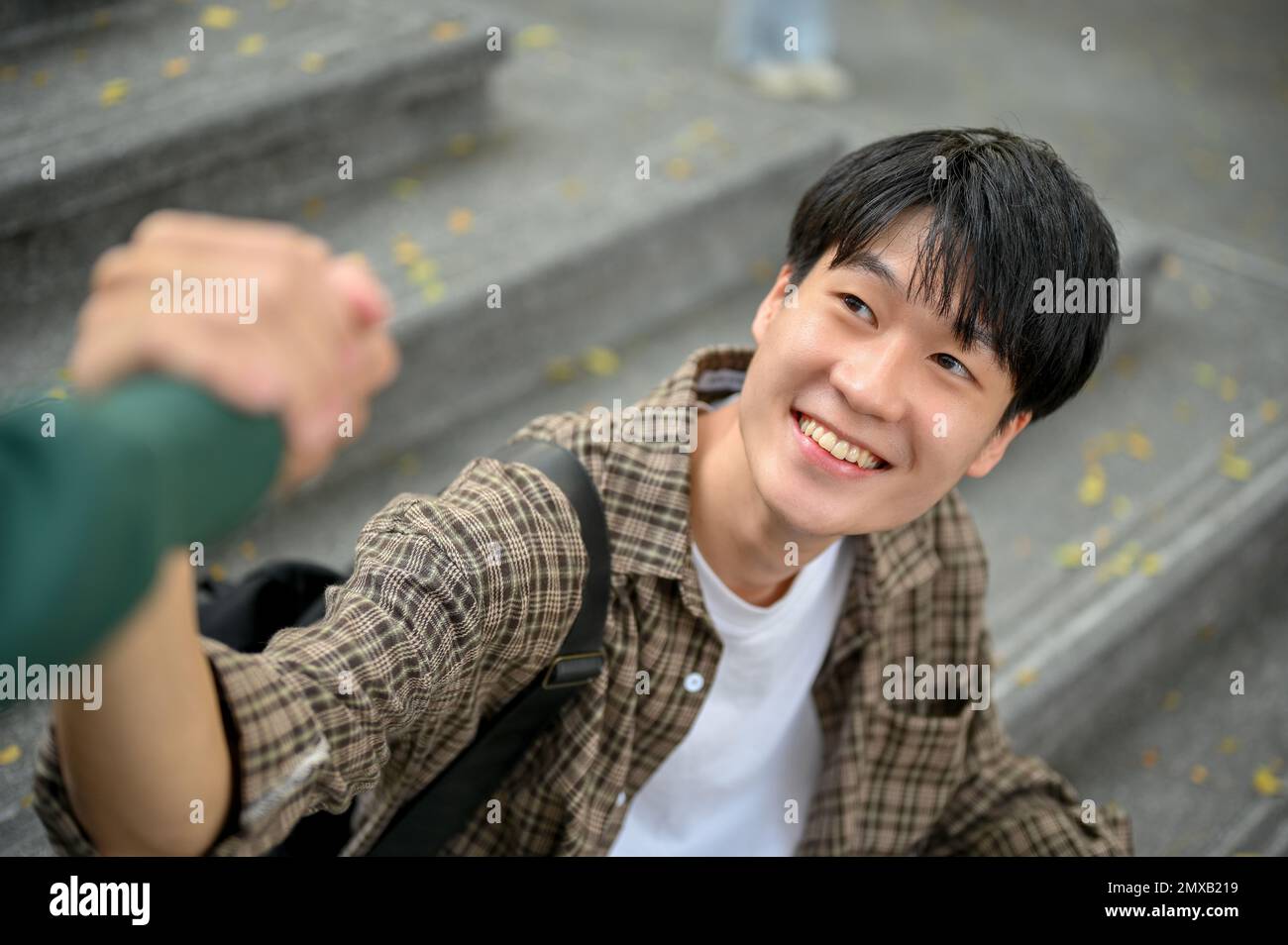 Close-up image of smiling and happy young Asian male college student ...