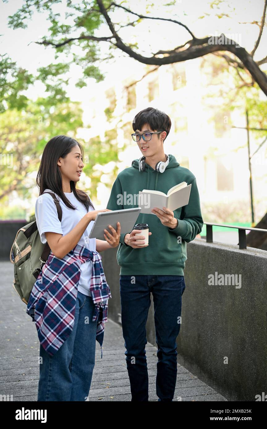 Portrait, Friendly young Asian male college student talking with his ...