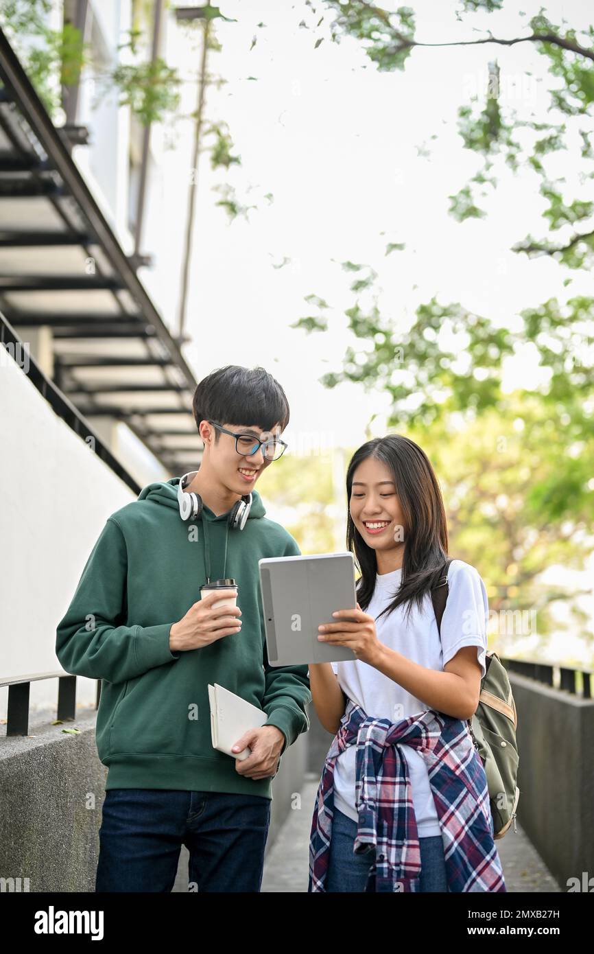 Happy and friendly young Asian male college students talking and ...