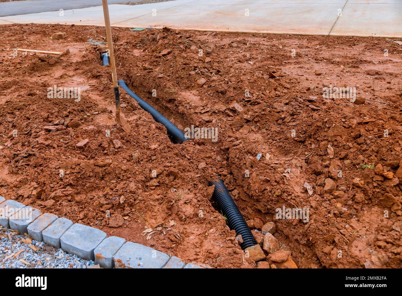 Drainage pipe for rain water is laid in lot of parking lot, which ...