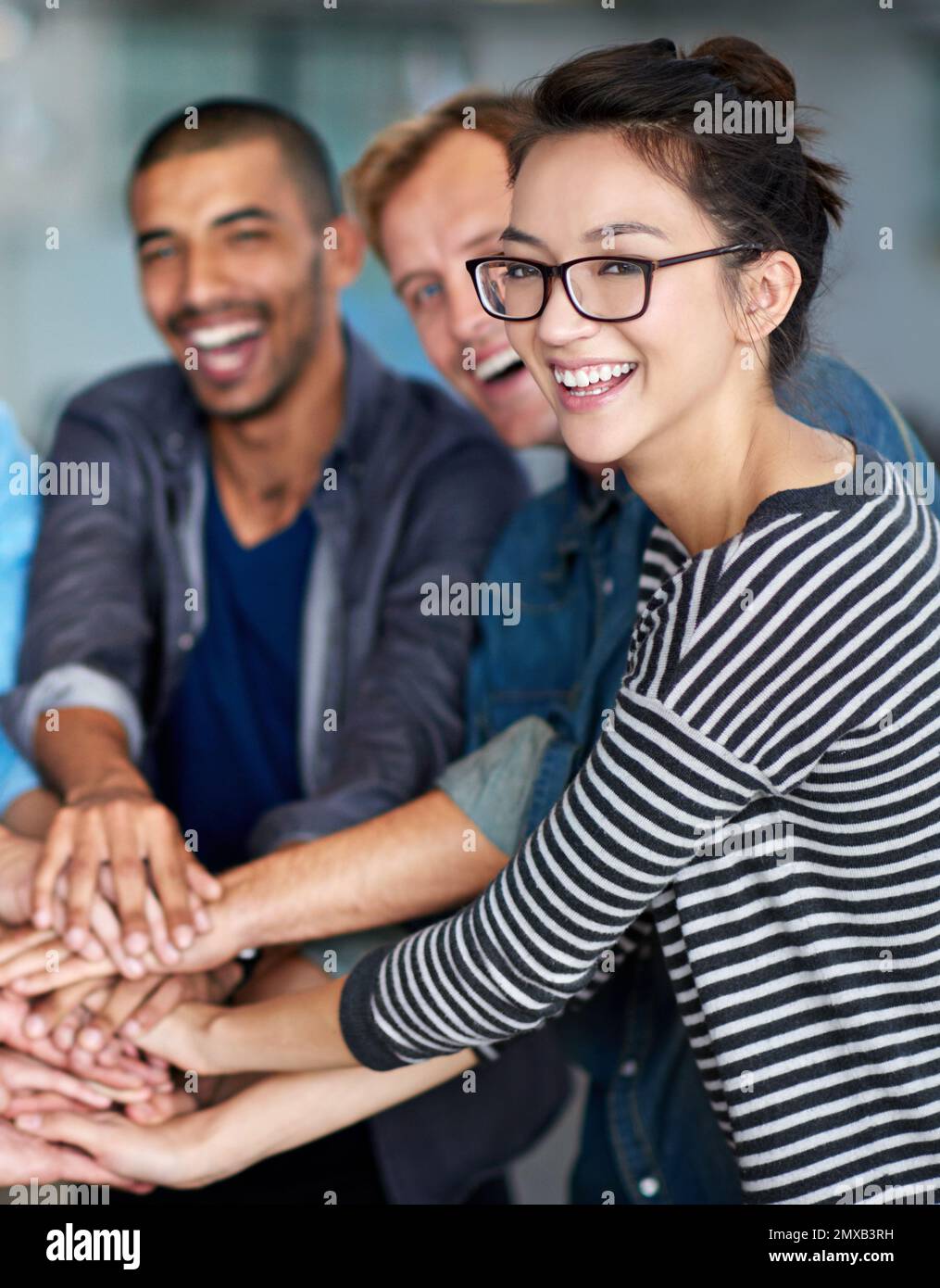 Weve got the right spirit. Friendly group of staff putting their hands ...