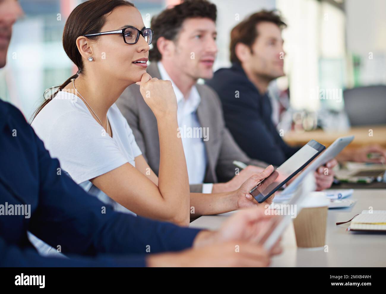 Very interesting presentation...business people around a table in a ...