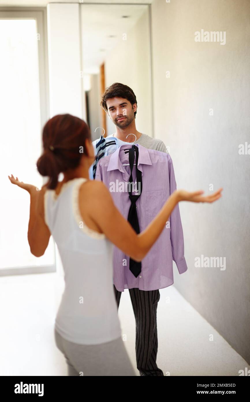 Just pick one already. Handsome man asking his wife what he should wear ...