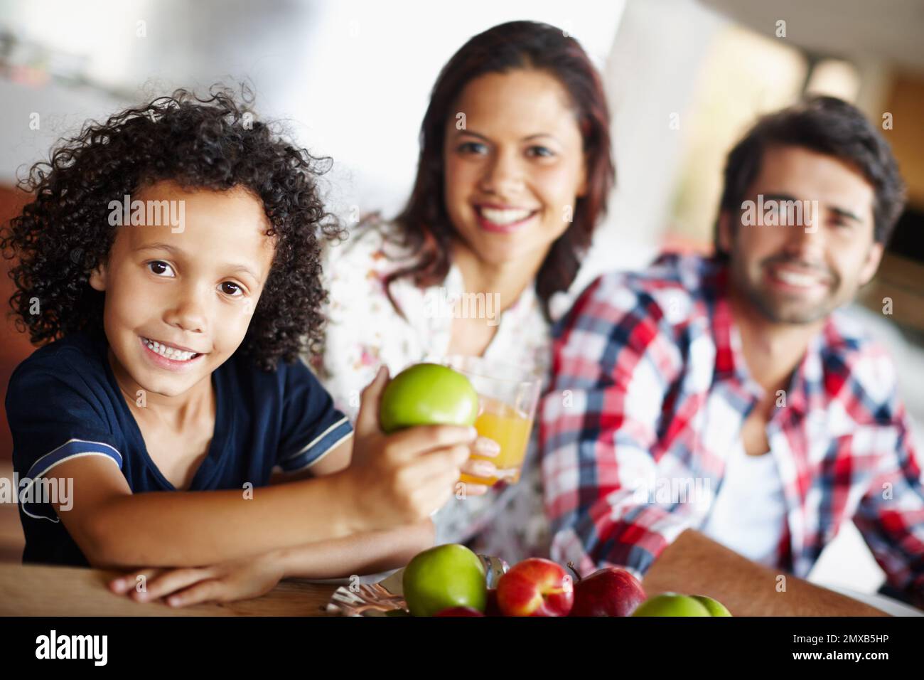 Fruit keeps our family healthy. A happy family enjoying a meal time ...