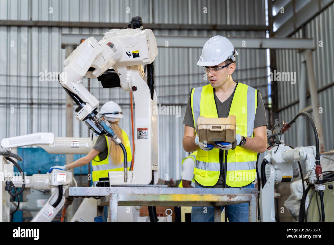 A team of male and female engineers meeting to inspect computer ...