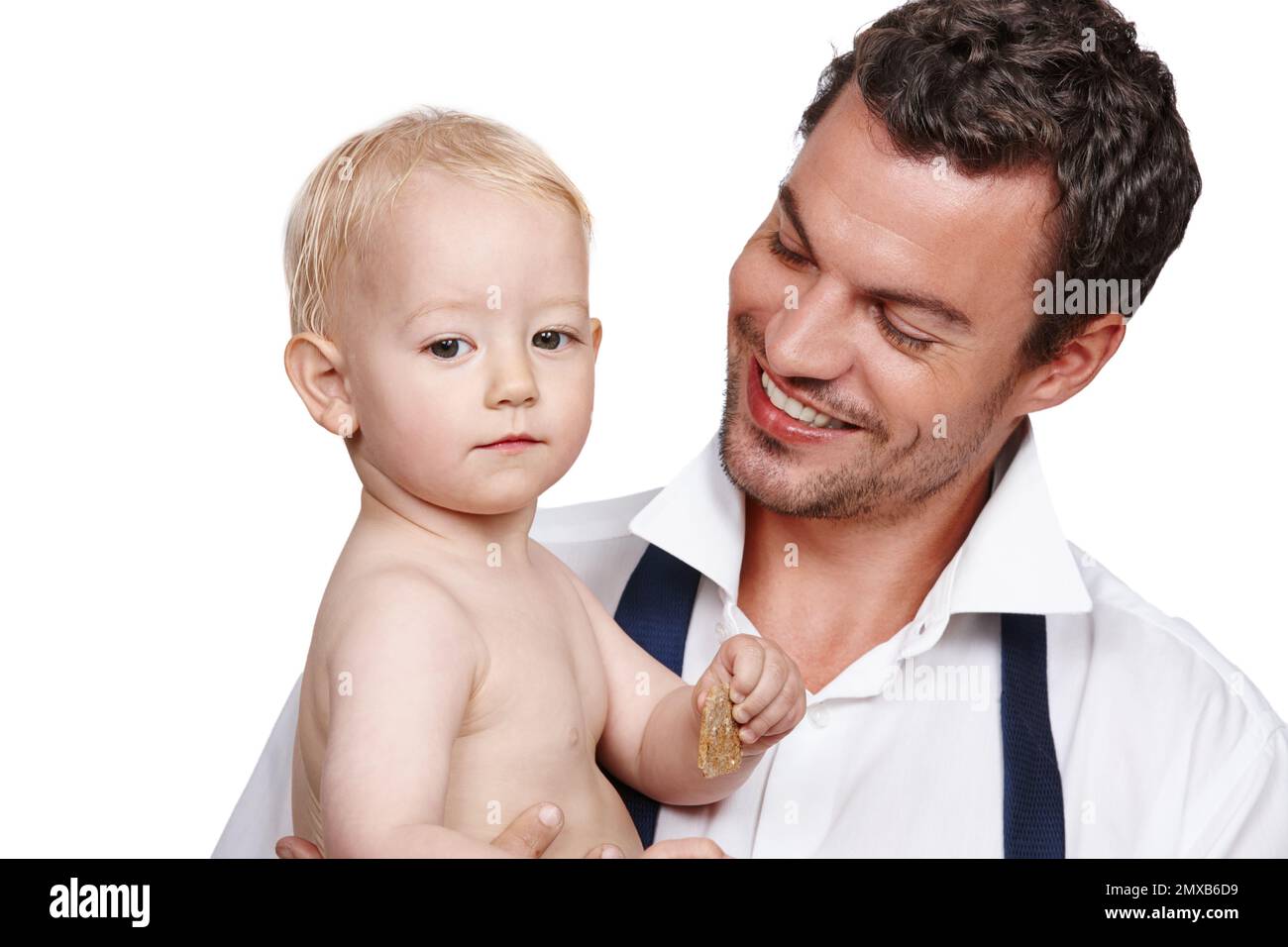 Happy with his son. A doting young father holding his son after a long ...
