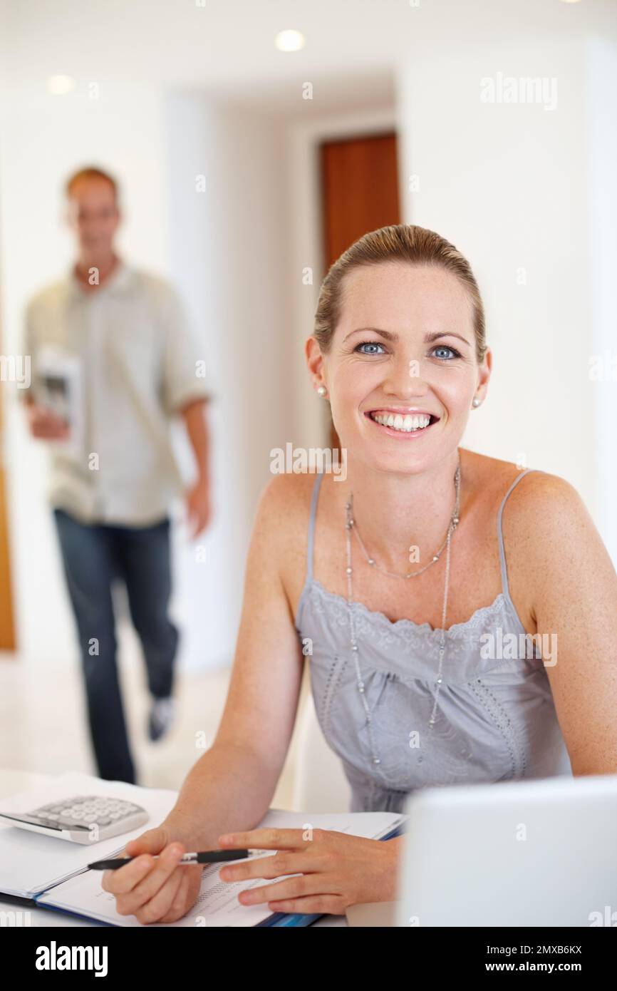 Working from home is a blessing. a beautiful young woman working from ...