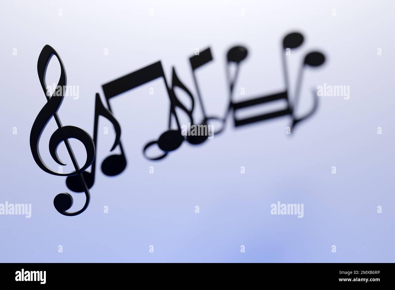 Musical notes and symbols with curves and swirls on a white background ...