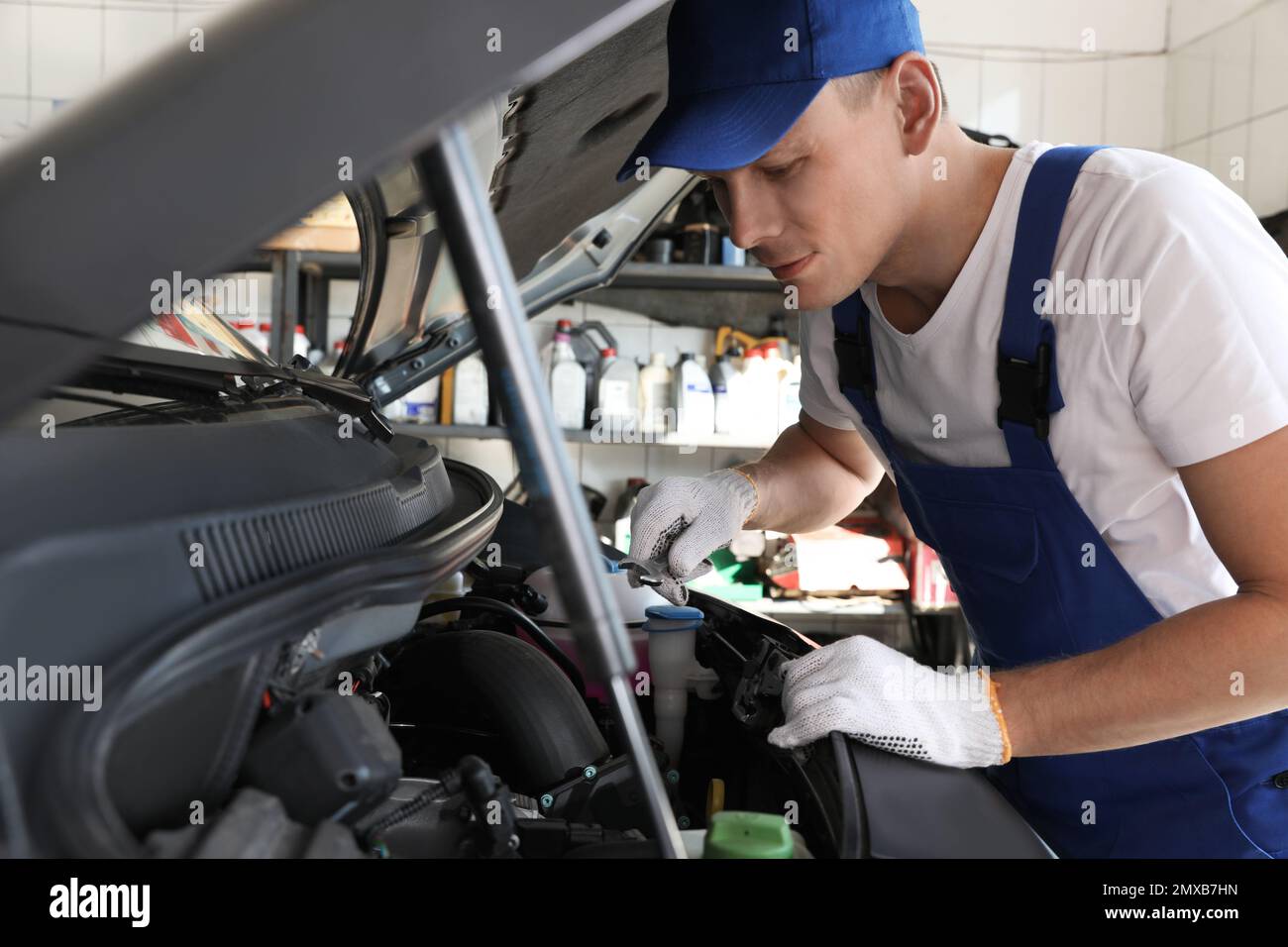 Professional auto mechanic fixing modern car in service center Stock ...
