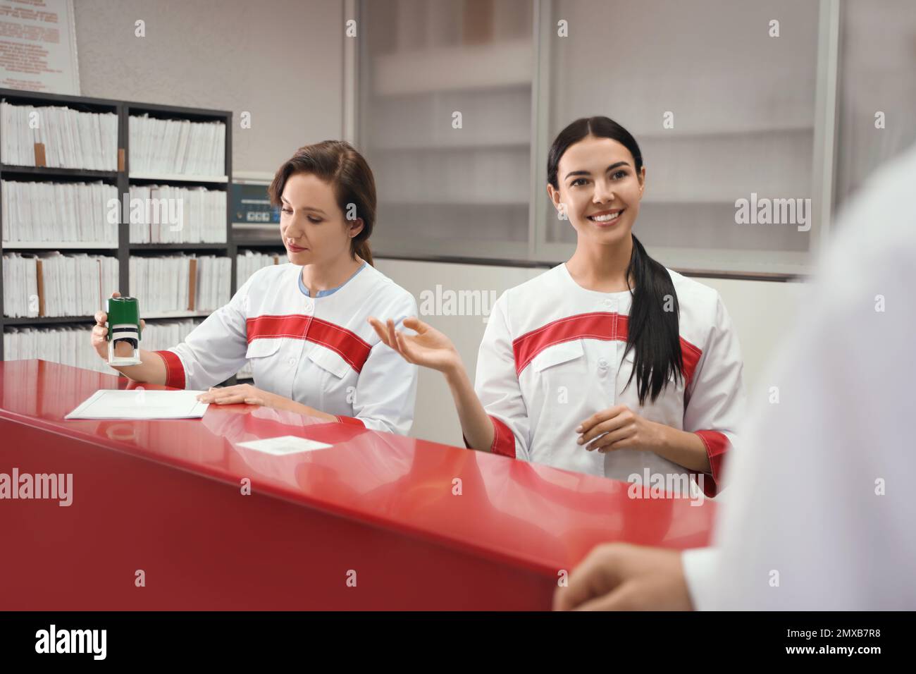 Reception of modern surgery clinic with working staff Stock Photo - Alamy