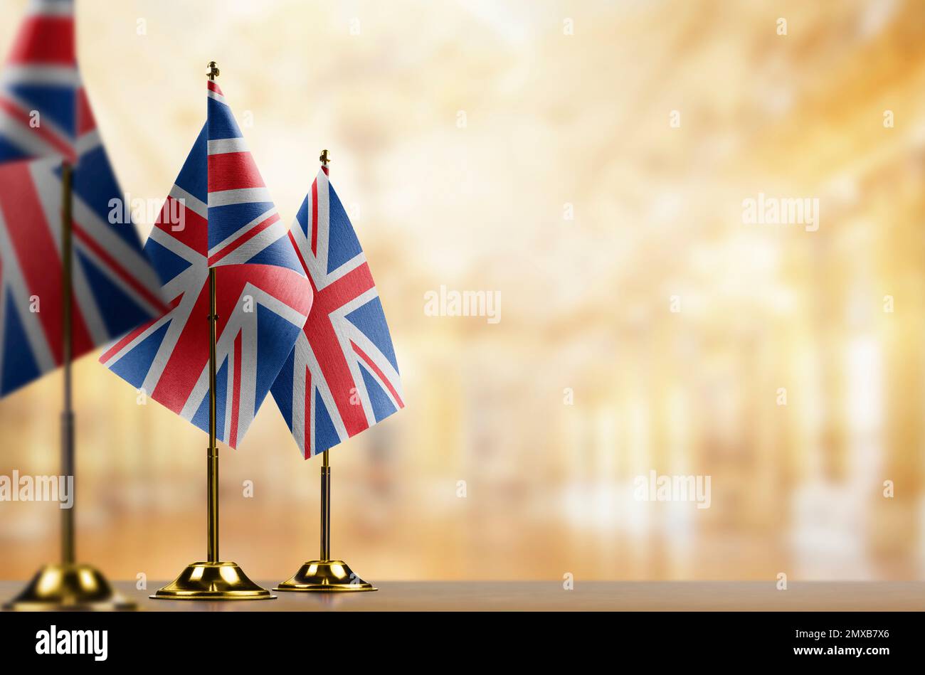Small flags of the United Kingdom on an abstract blurry background ...