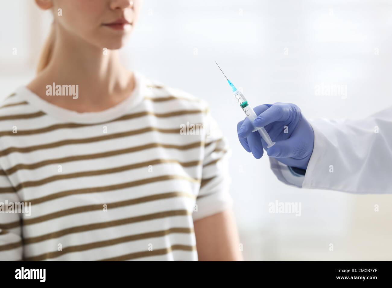 Doctor giving injection to patient in hospital, closeup. Vaccination ...