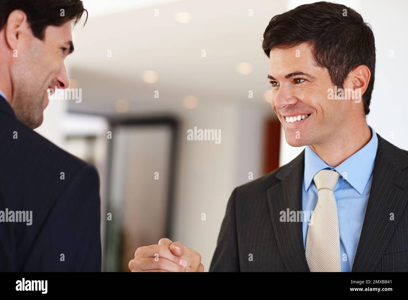 Yet another deal secured. two businessmen shaking hands Stock Photo - Alamy
