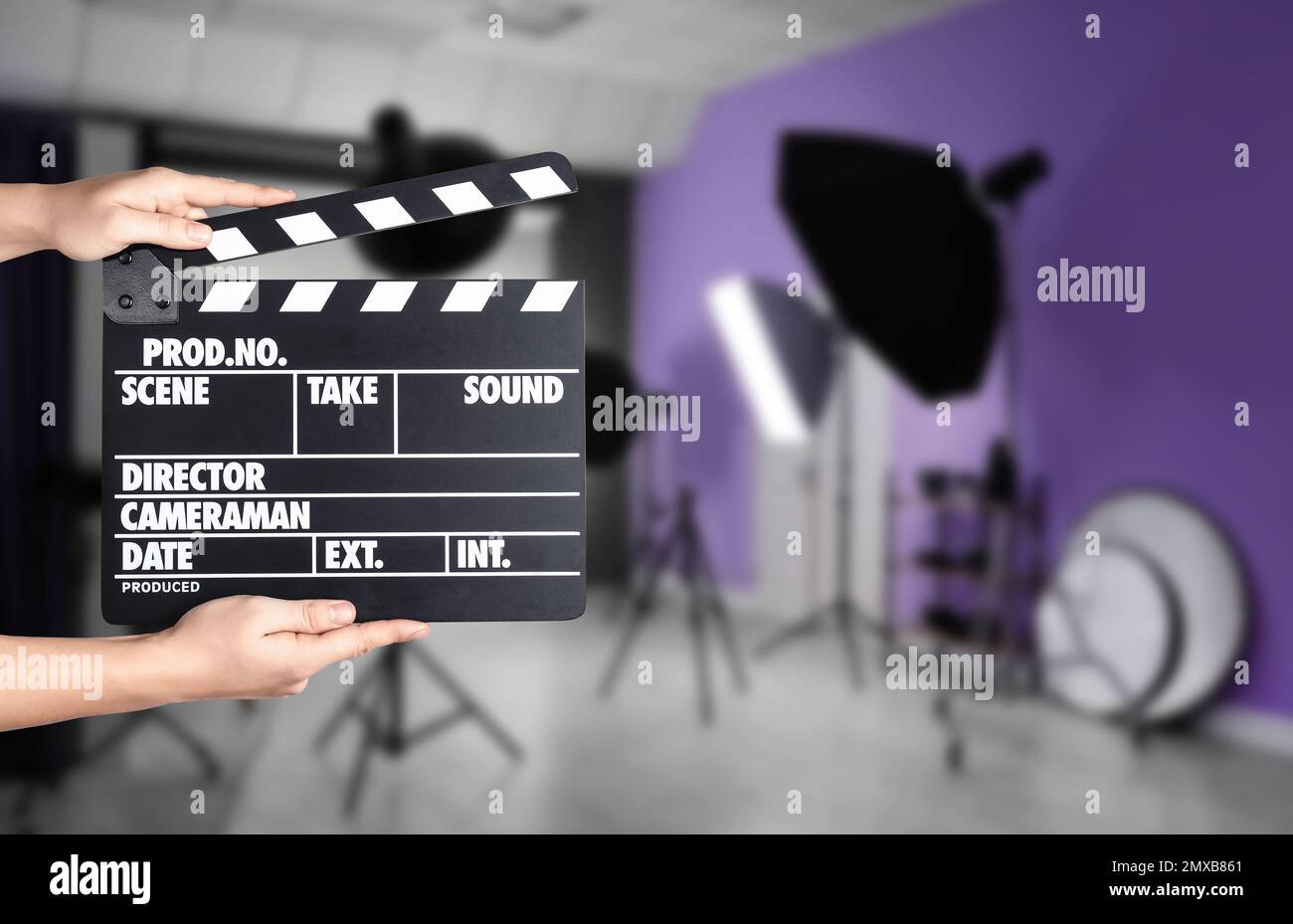 Assistant holding clapperboard on filming location, closeup. Cinema ...