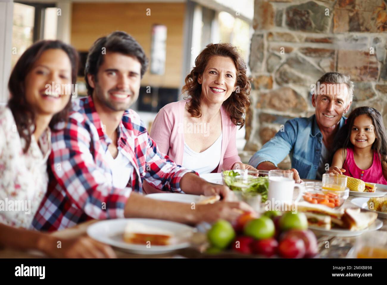 Family meals bring us together. A happy family enjoying a meal time ...