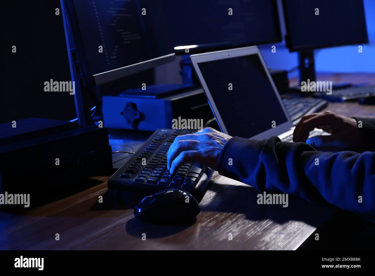 Hacker with computers in dark room, closeup. Cyber crime Stock Photo ...
