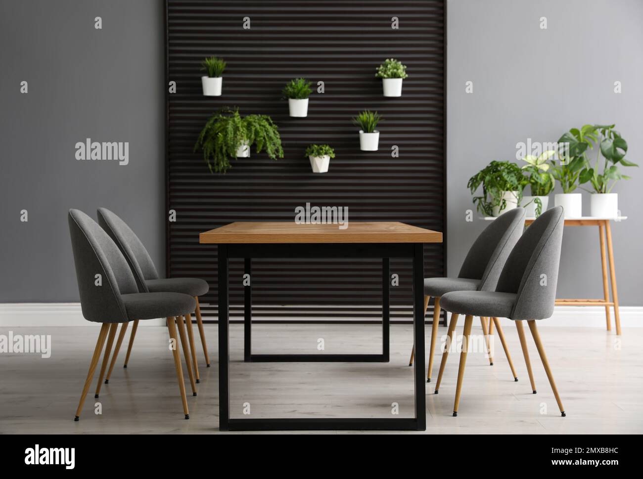 Stylish room with table, chairs and plants. Interior design Stock Photo ...