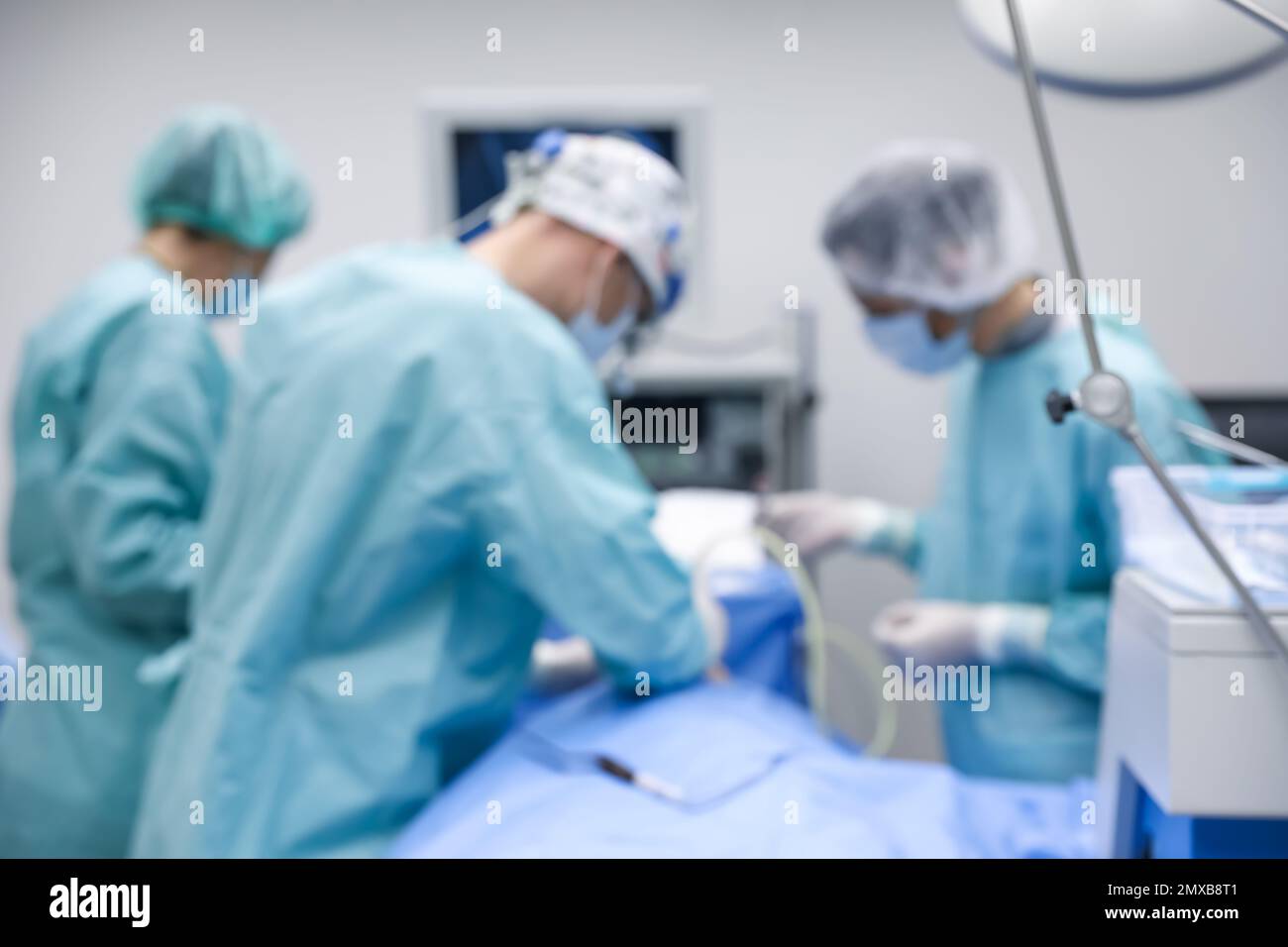 Blurred view of doctors operating patient in surgery room Stock Photo ...