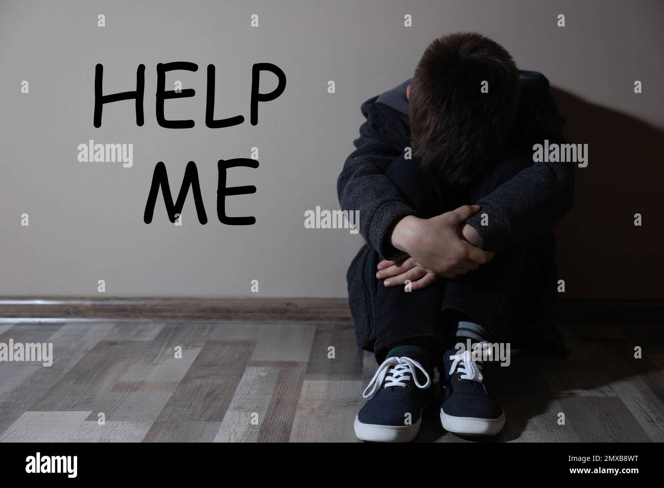 Scared little boy indoors and text HELP ME Stock Photo - Alamy