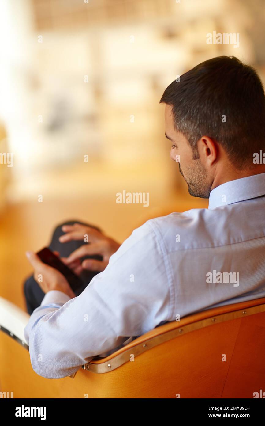 Constant corporate connection. A young businessman making use of his ...