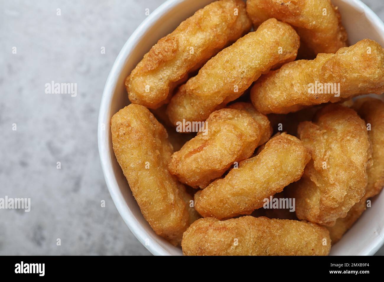 Bucket with tasty chicken nuggets on grey table, top view Stock Photo ...