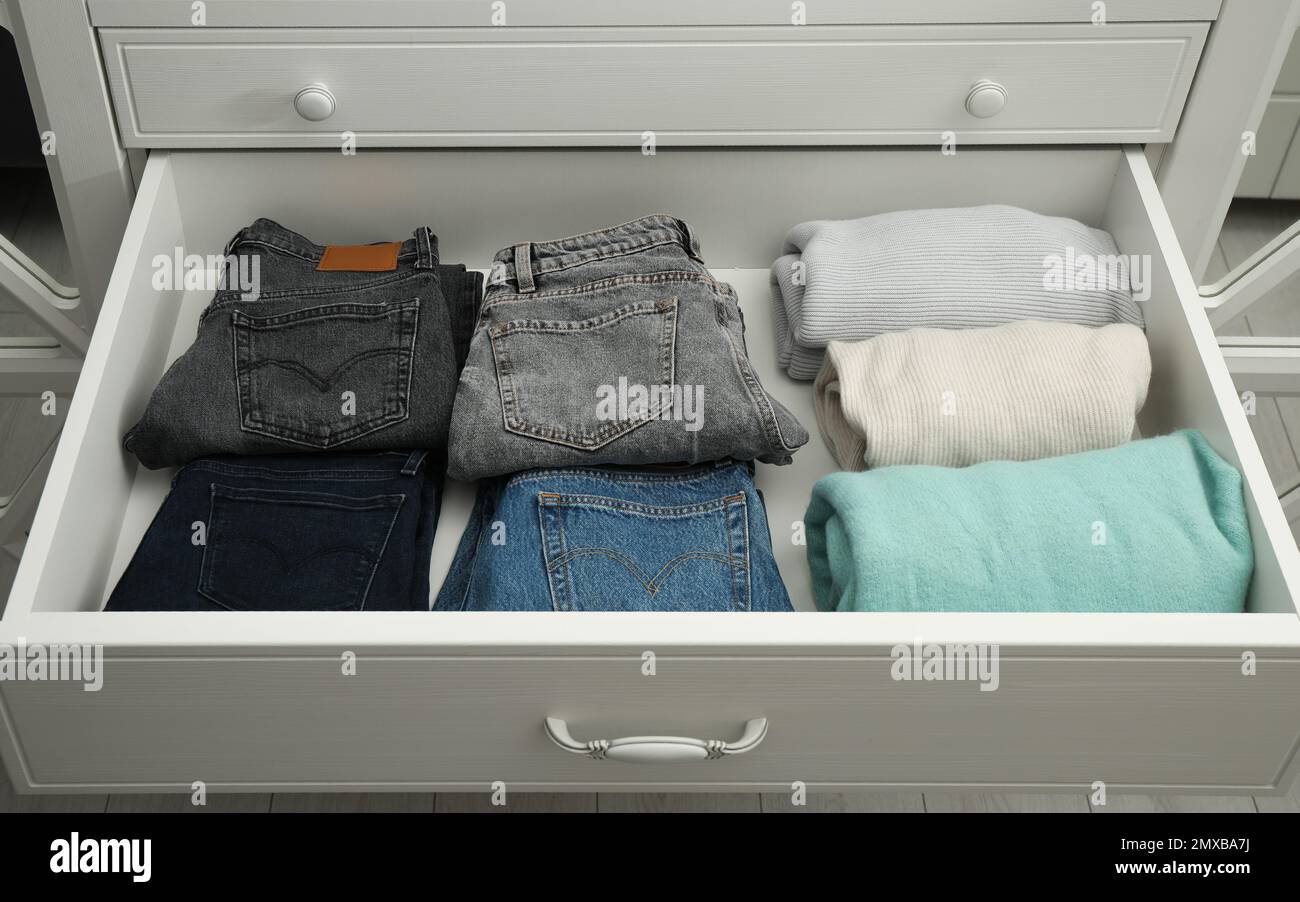 Folded clothes in open drawer. Apparel storage Stock Photo - Alamy