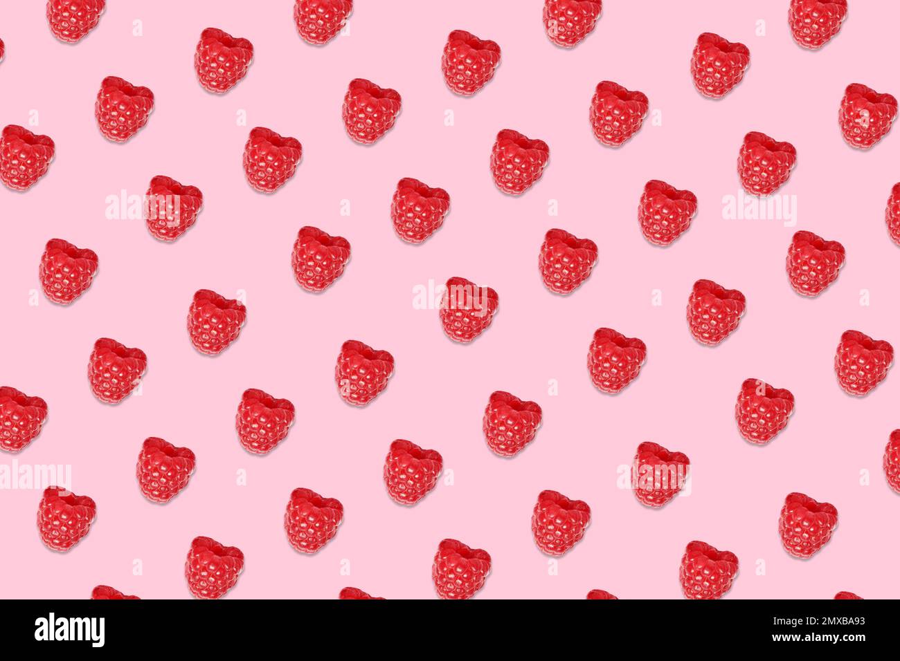 Pattern of raspberries on pale pink background Stock Photo - Alamy