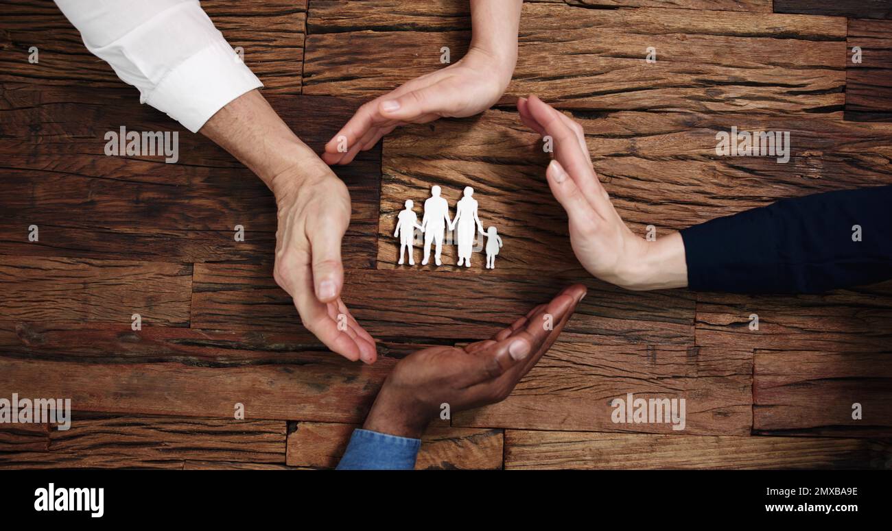 Group Of Hands Protecting Family Paper Cut Out Stock Photo - Alamy