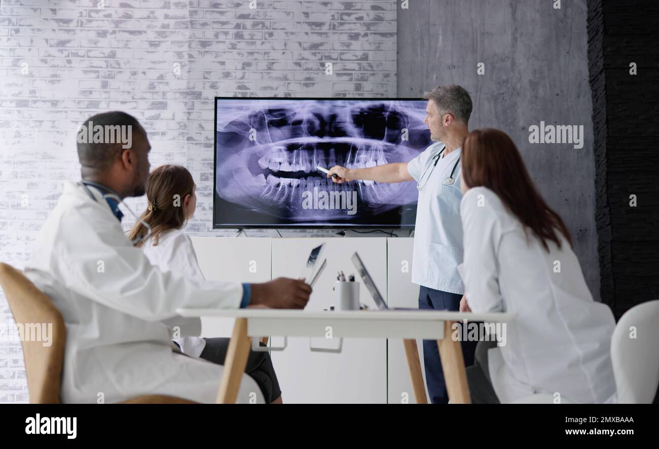 Dentist Doctors Looking At Teeth Xray Using Computer Software Stock ...