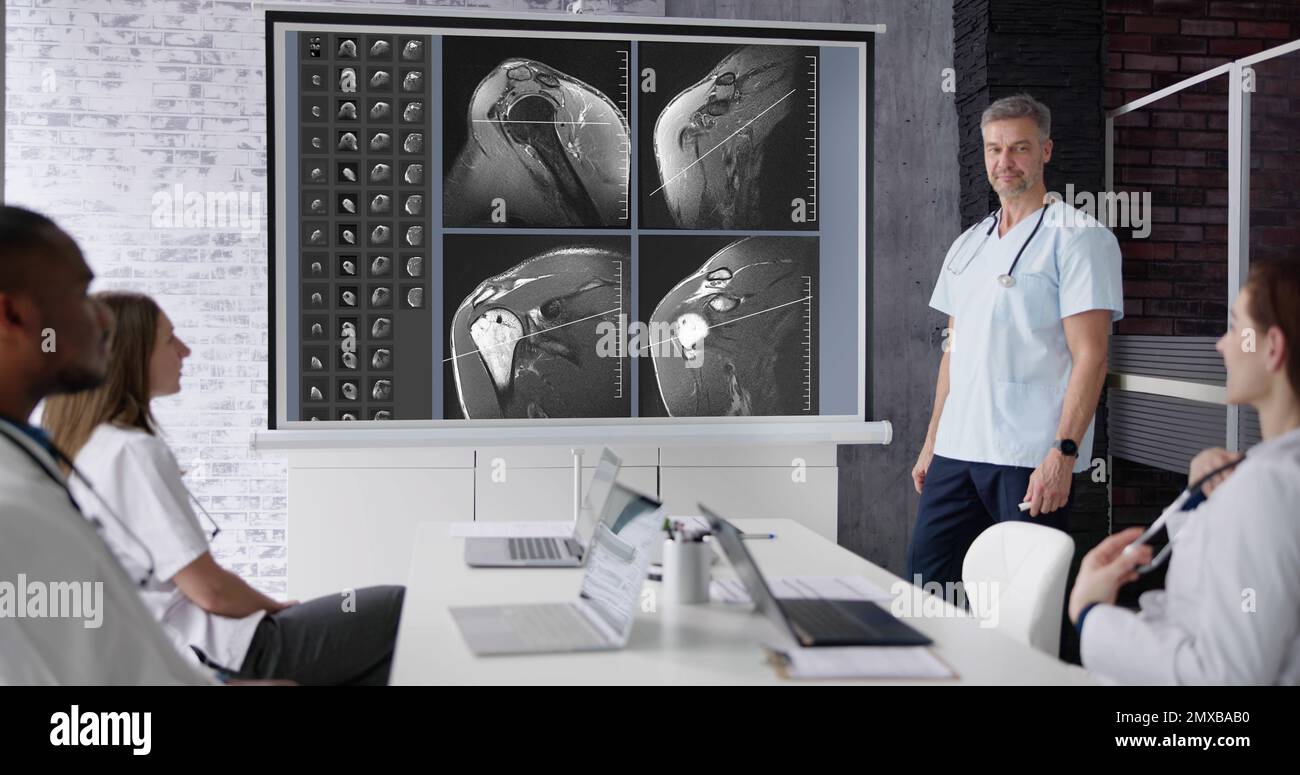 Physician Doctors Looking At Shoulder MRT Scan Stock Photo - Alamy