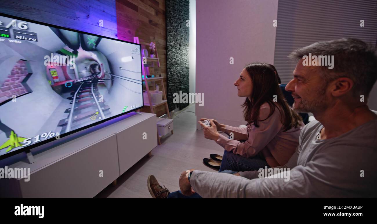 Rear View Of An People Playing Video Games At Home Stock Photo - Alamy