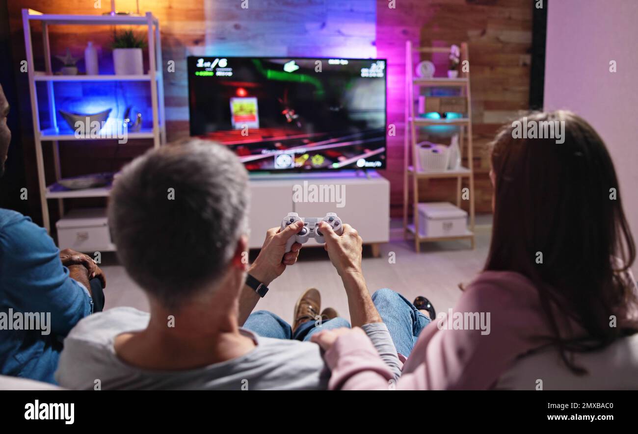 Rear View Of An People Playing Video Games At Home Stock Photo - Alamy