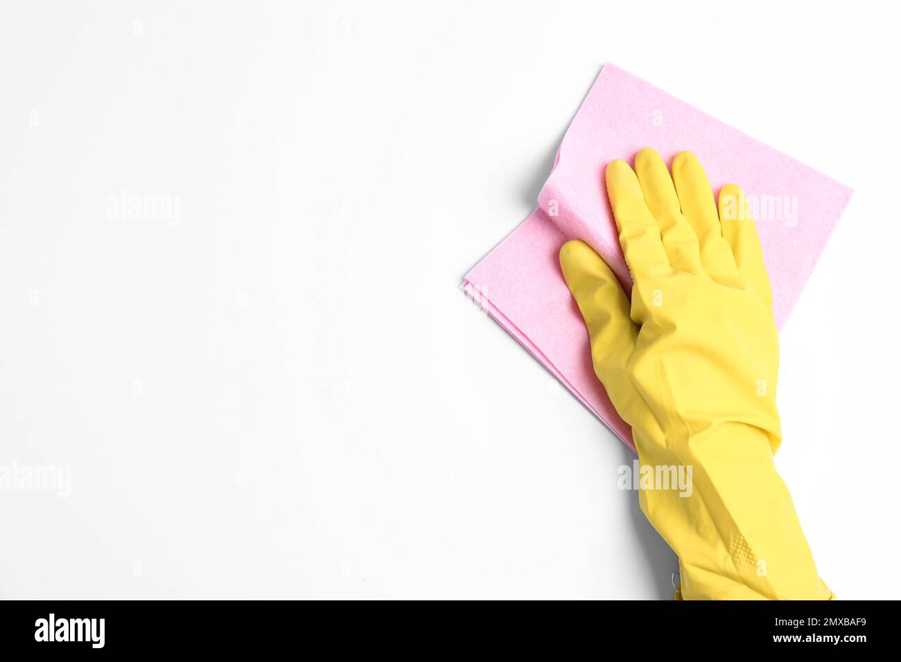 Person in rubber glove with rag on white background, closeup of hand ...