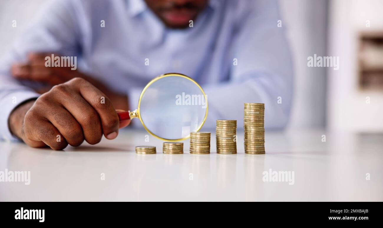 Analyze And Monitor Expenses With Magnifying Glass Stock Photo - Alamy