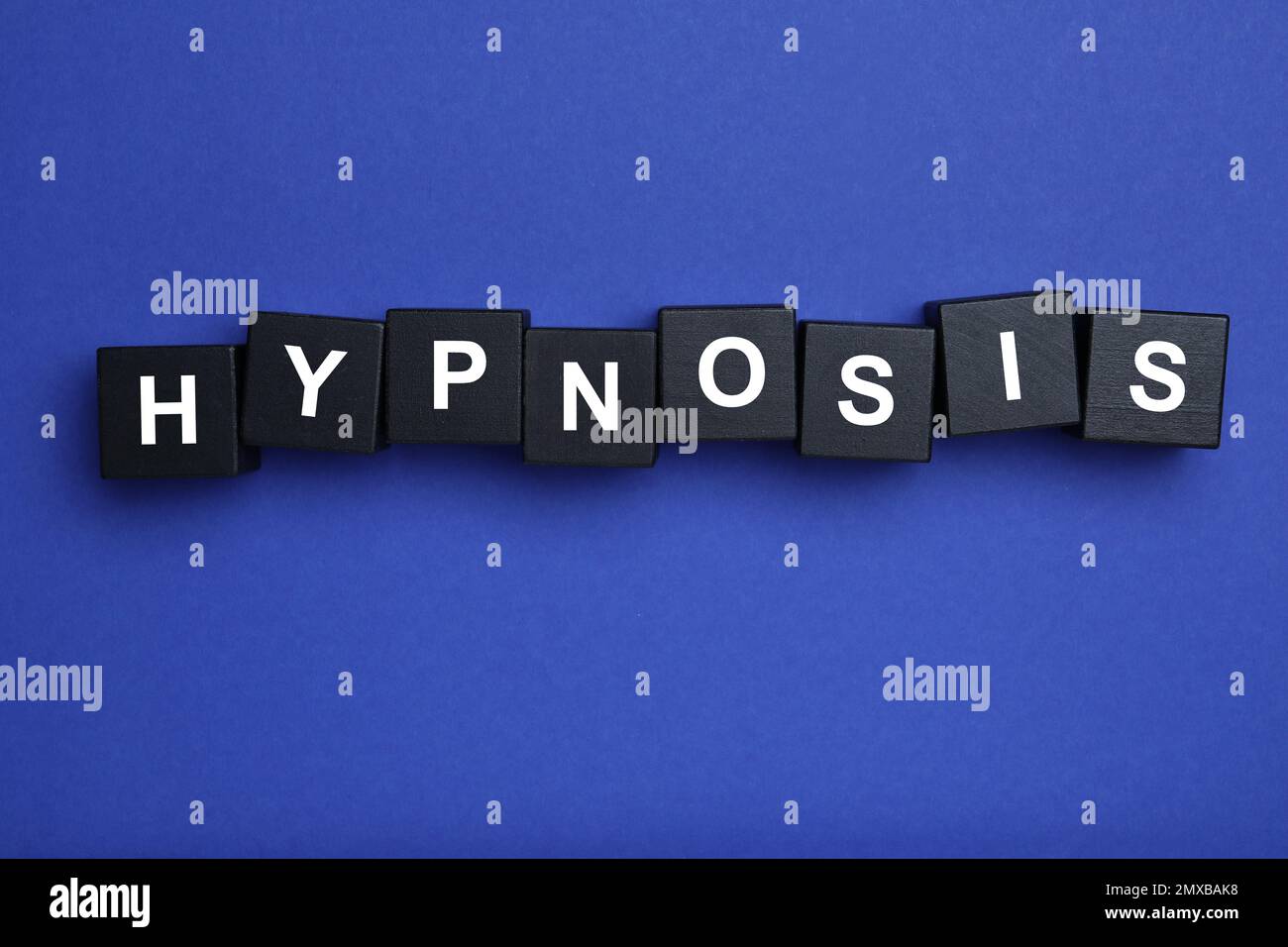 Black wooden blocks with word HYPNOSIS on blue background, flat lay ...