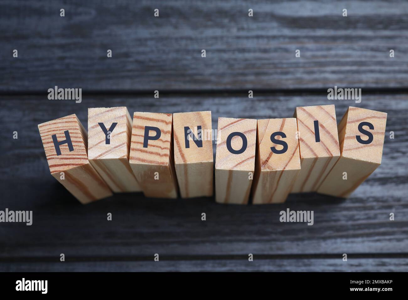 Wooden blocks with word HYPNOSIS on black background, above view Stock ...