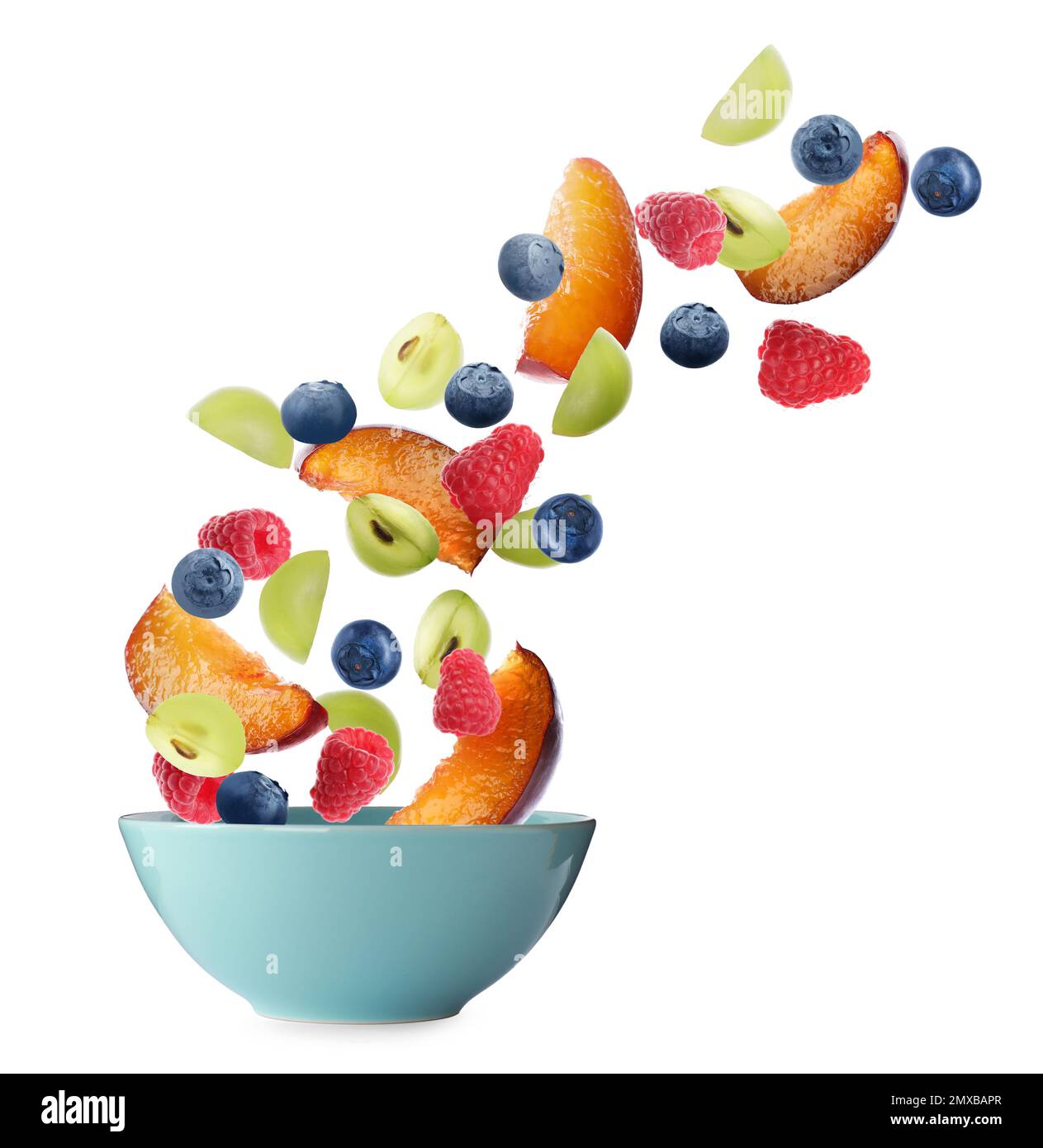 Fresh tasty fruits and berries falling into bowl on white background ...