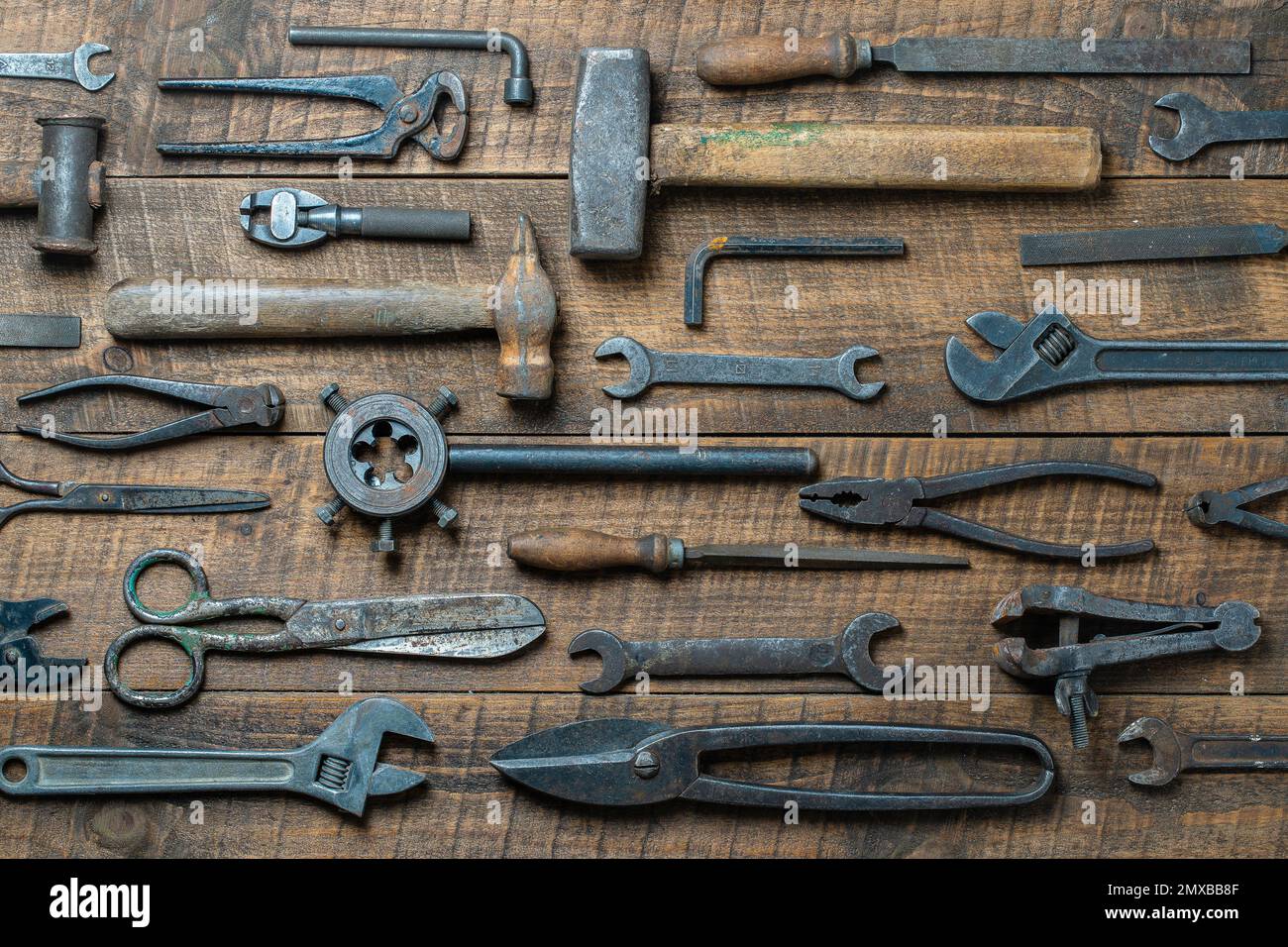Vintage tools displayed on a background of wooden board, close up, top ...