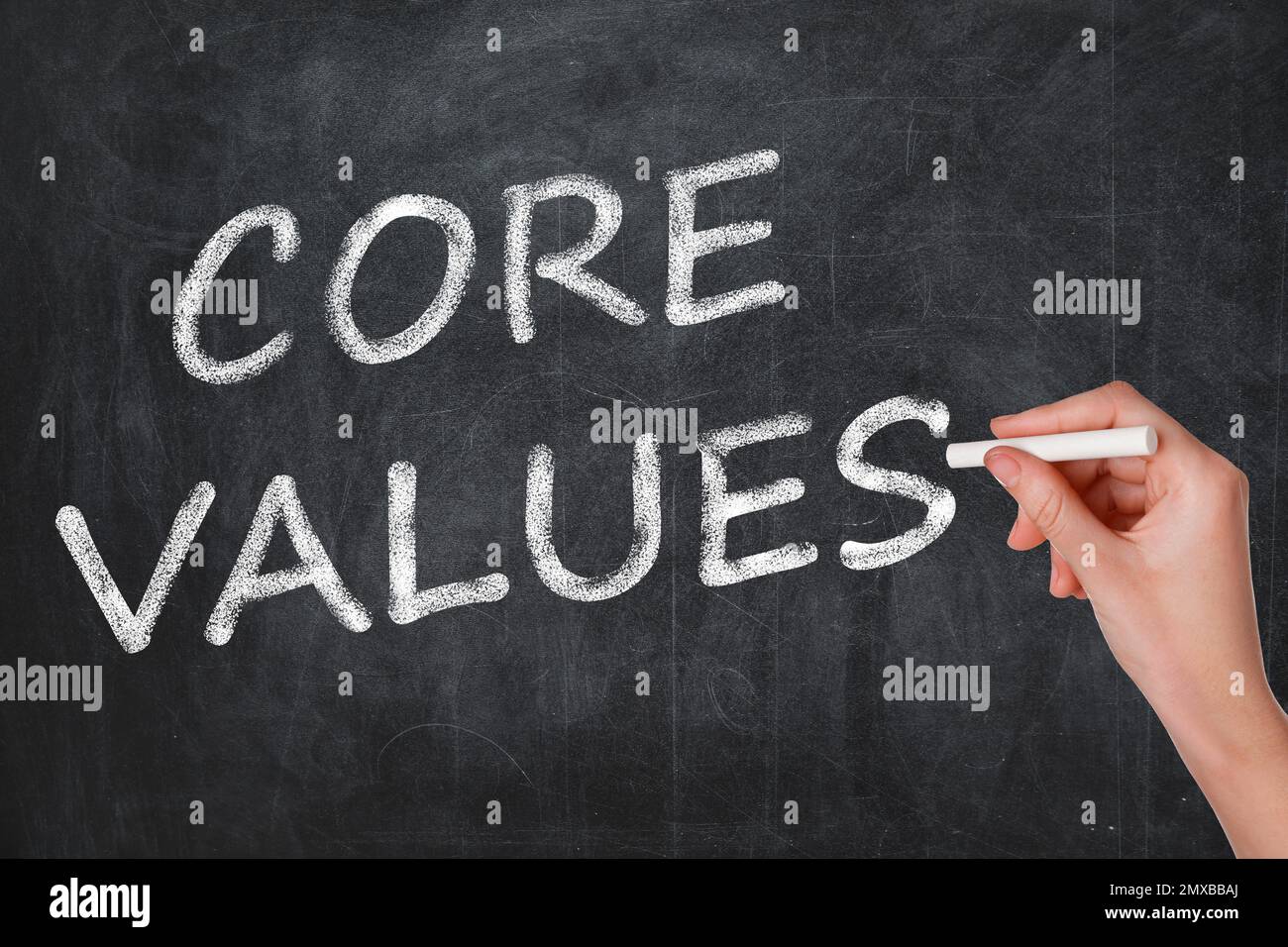 Woman writing phrase CORE VALUES on blackboard, closeup Stock Photo - Alamy