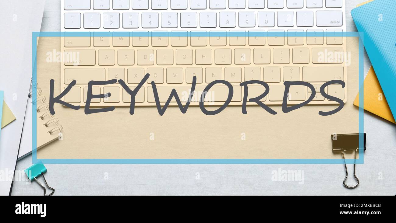 Text KEYWORDS and keyboard on light background, flat lay. Banner design ...