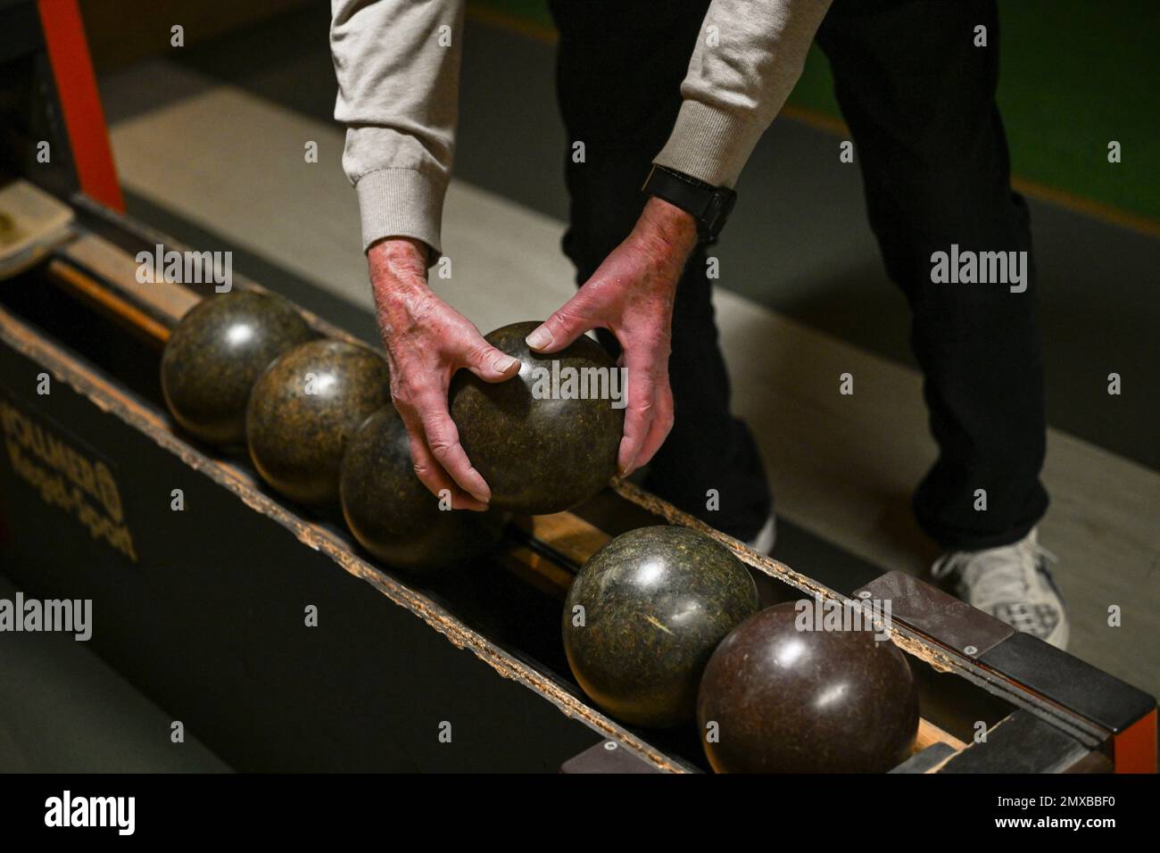 Berlin, Germany. 01st Feb, 2023. A man takes a ball from the ball ...