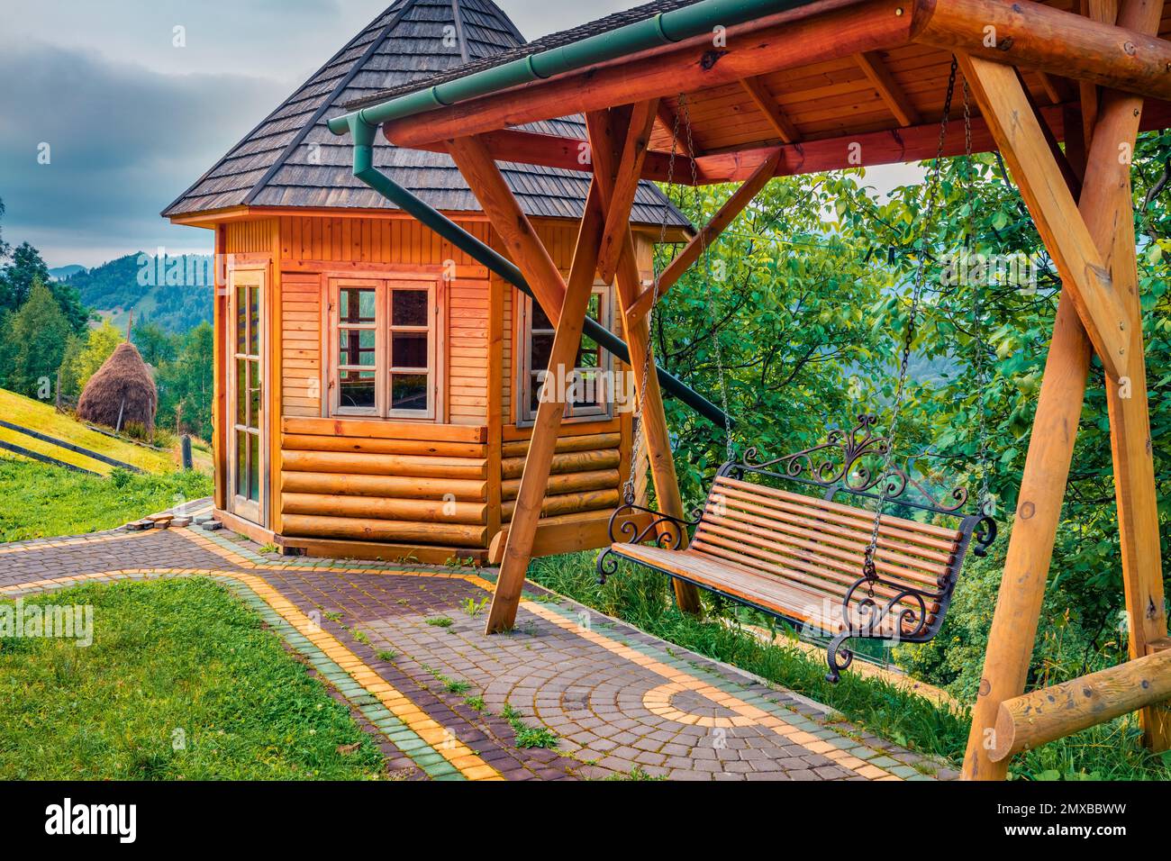 Wodden chalet and swing on the yard of Carpachian village. Wonderful ...
