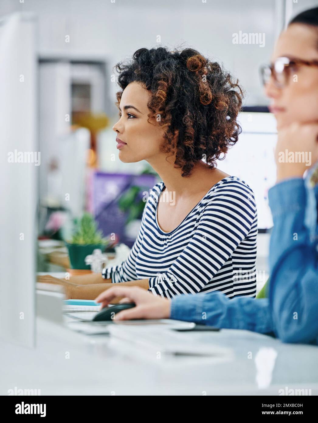 Trouble shooting tech is my specialty. a young office worker sitting at ...