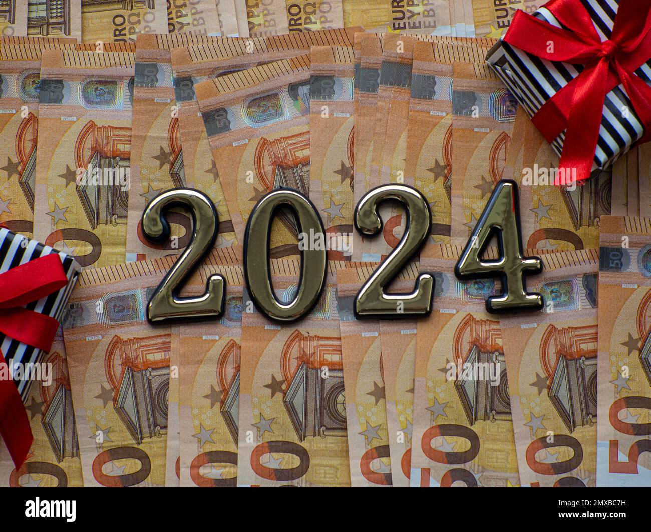 2024 and gift boxes on the background of fifty euros banknotes Stock ...