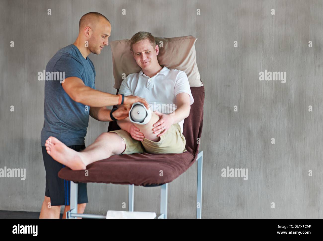 Appointment with the physio. Studio shot of a young amputee training in ...