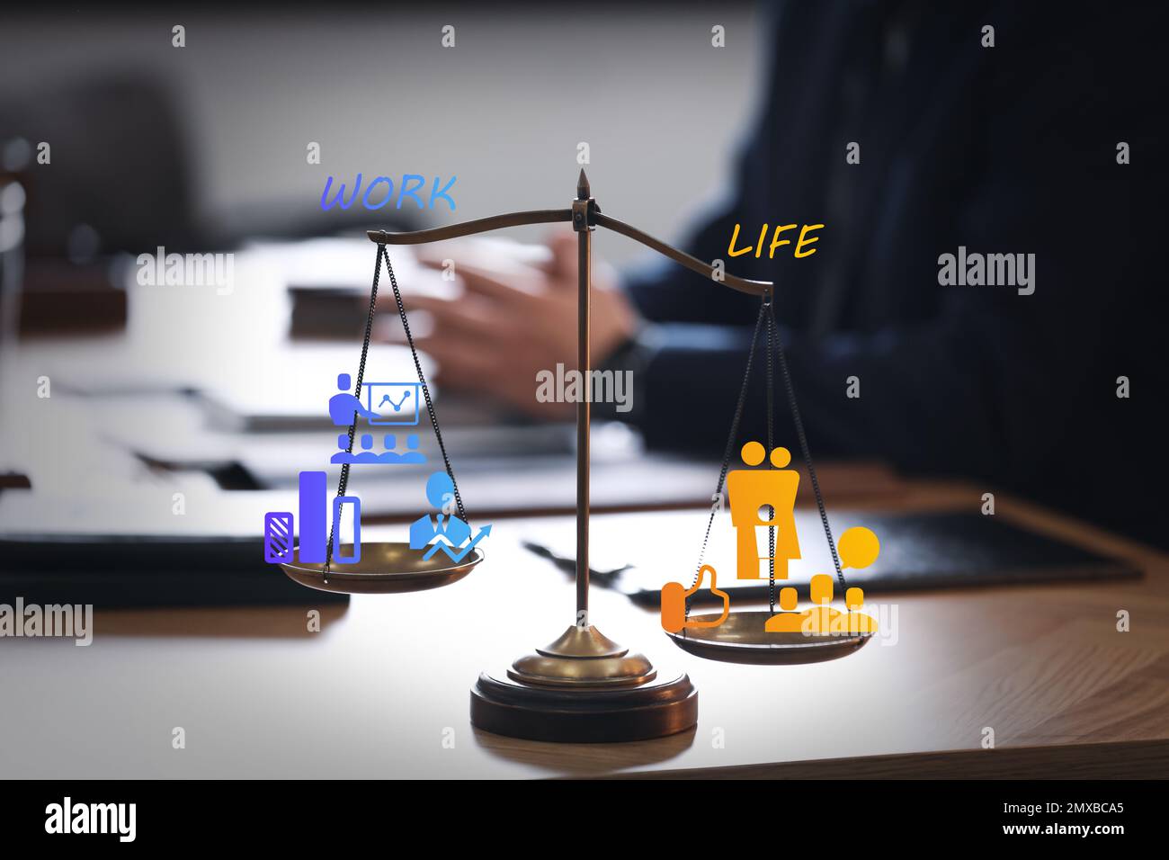 Work-life balance concept. Scale with images on table Stock Photo - Alamy